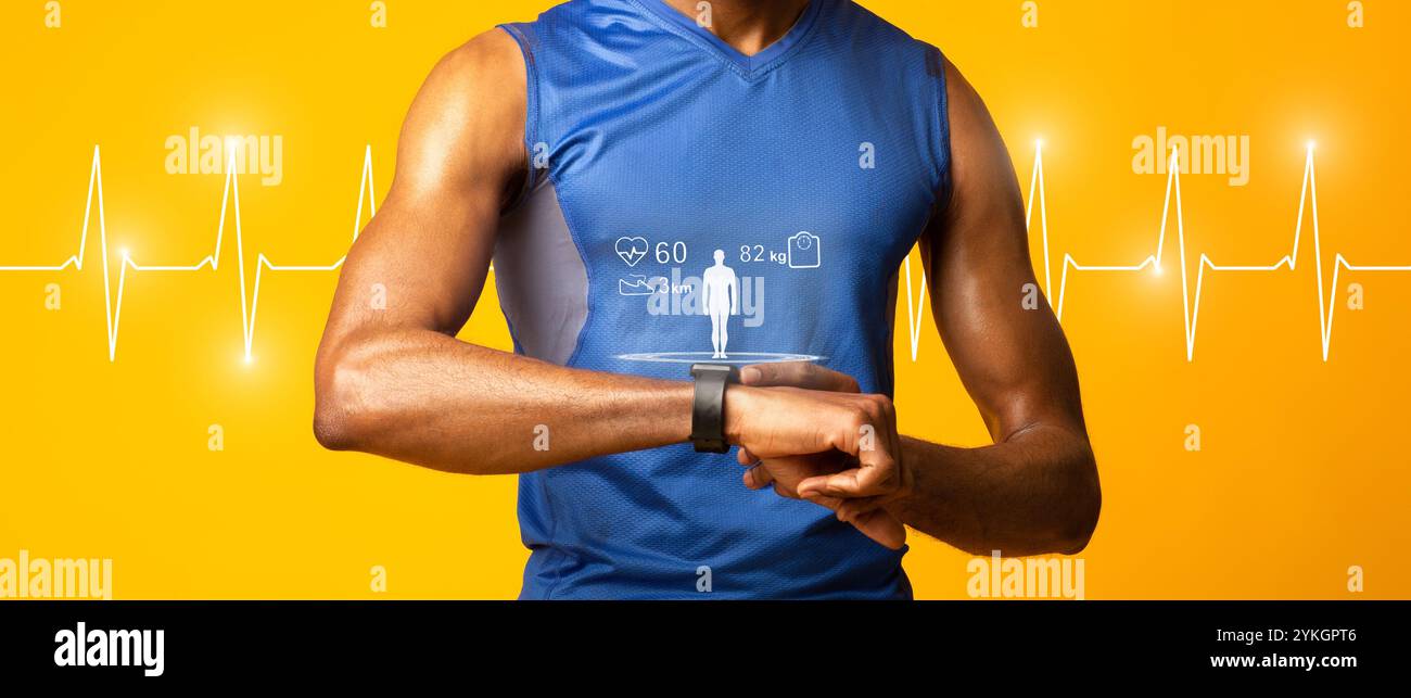 Muscular afro guy looking at smart watch Stock Photo - Alamy