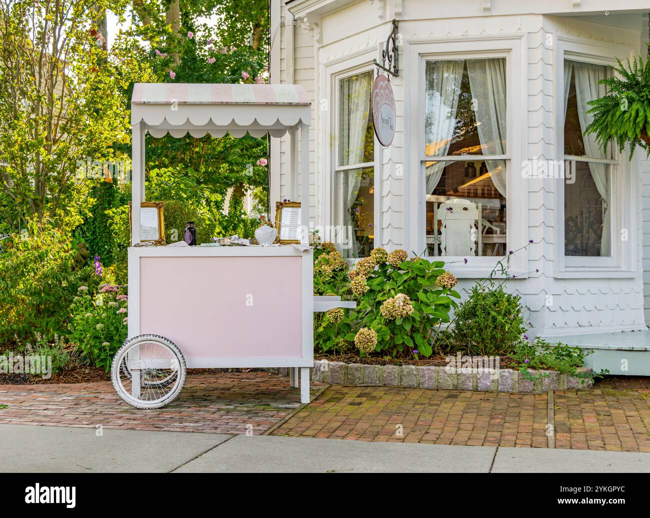 cute pink and white push cart in front of an old house in greenport ...