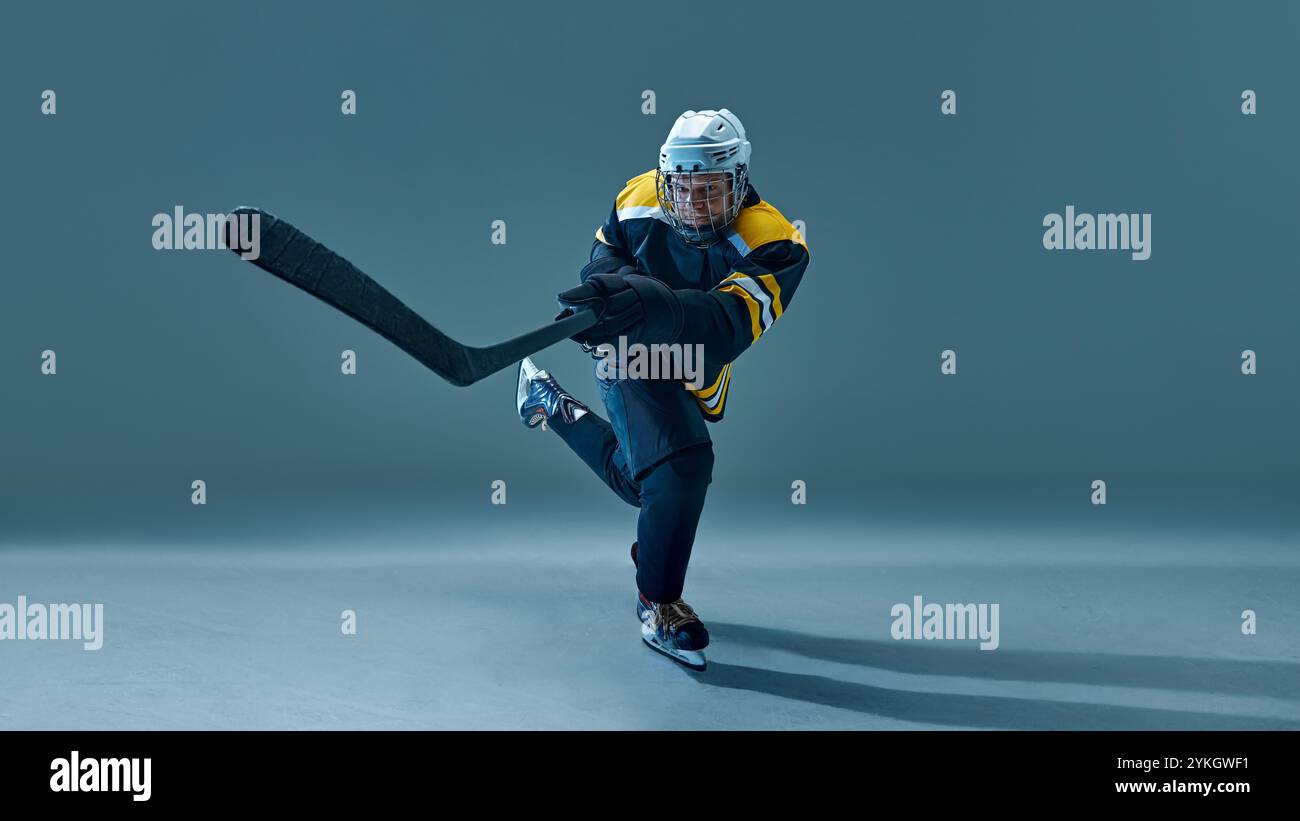 Focused man, ice hockey player captured in motion, powerfully skating ...