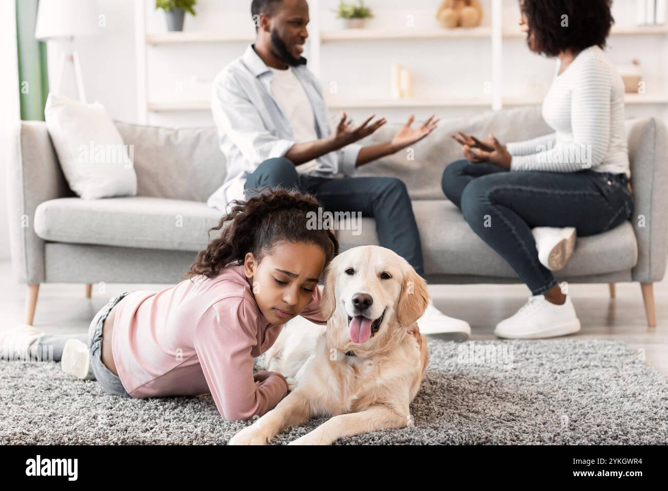 Sad girl embracing dog, parents fighting in the background Stock Photo ...