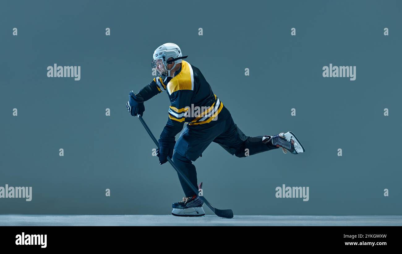 Dynamic full-length image of man, hockey player in motion during game ...