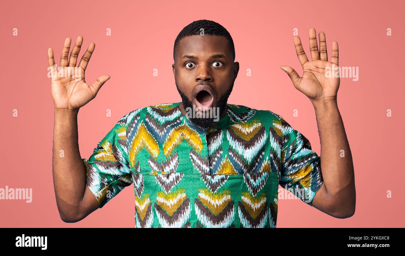 Shocked black guy with hands up and open mouth Stock Photo - Alamy