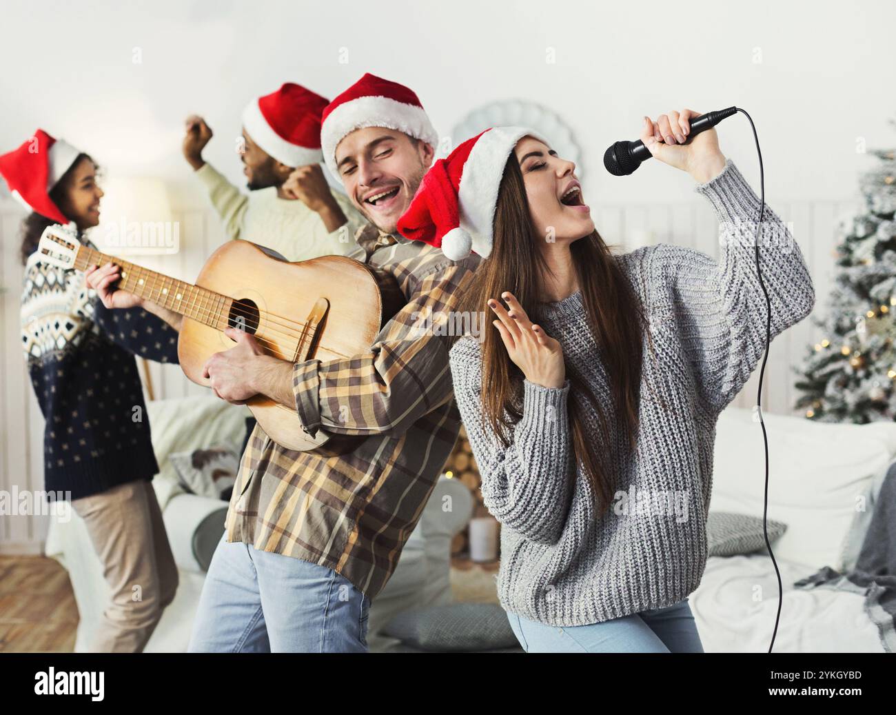 Happy friends singing together and playing on guitar Stock Photo - Alamy