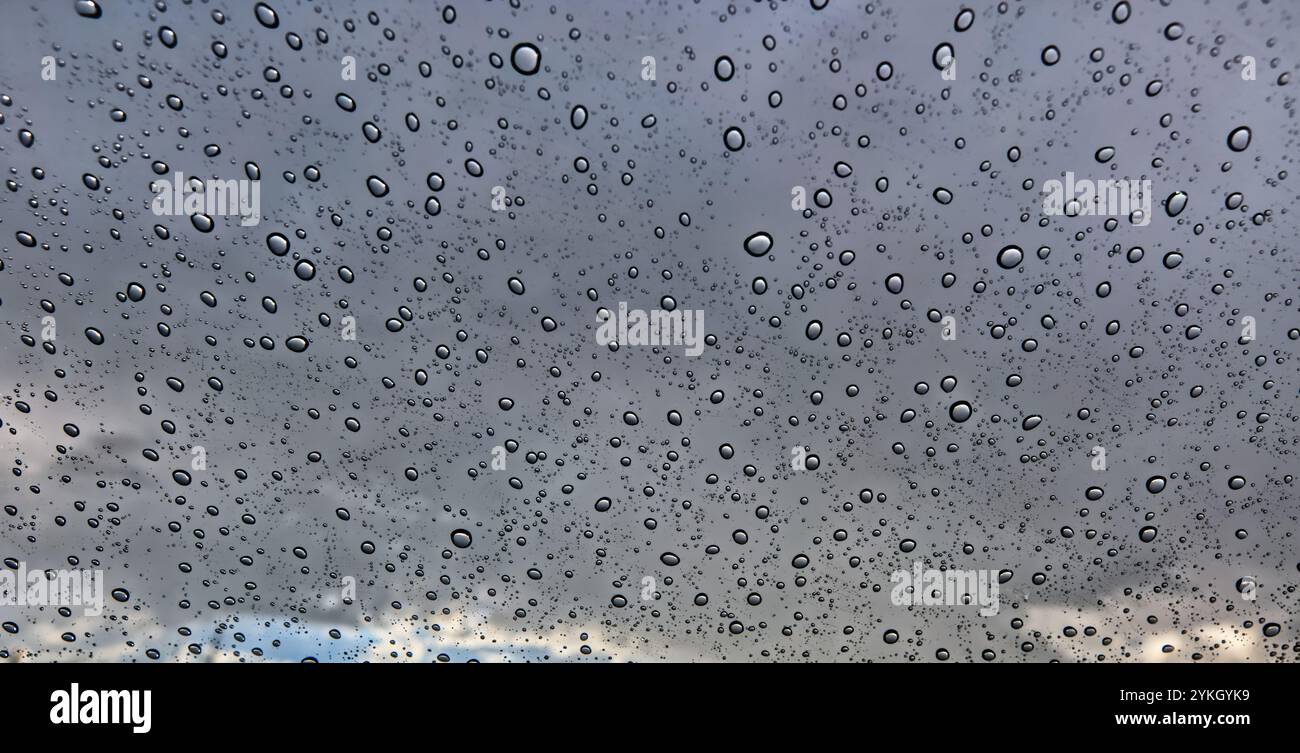 Random patterns of raindrops view thru a car windshield Stock Photo - Alamy