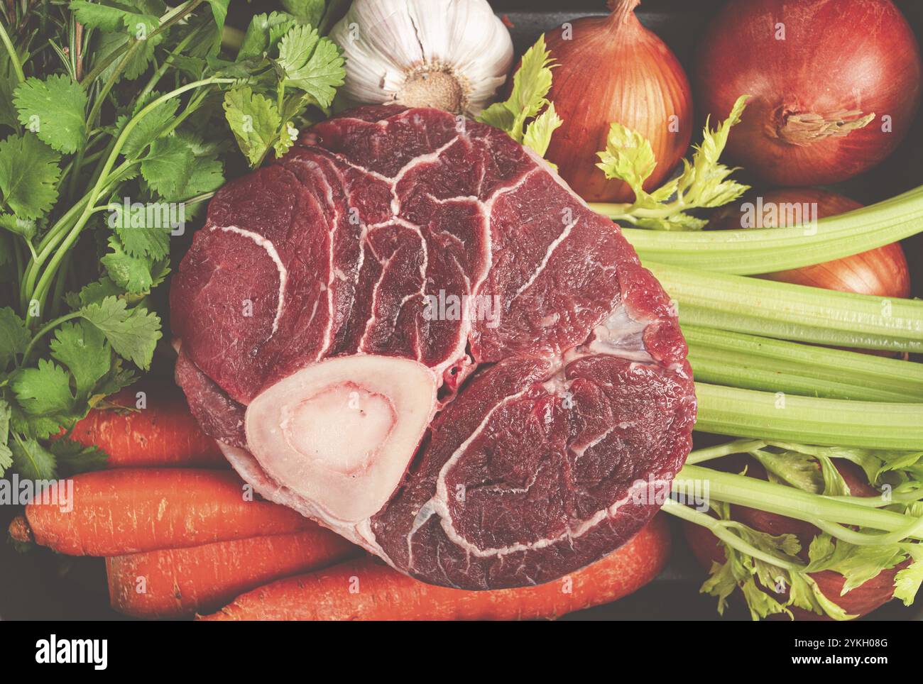 Knuckle on the bone, raw meat for ossobuco, with vegetables, in a ...