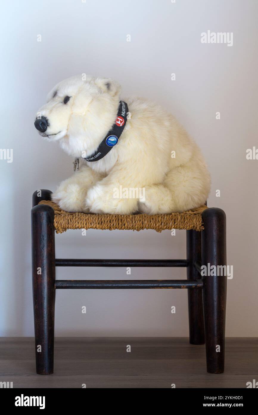 Polar Bear soft cuddly toy sitting on stool Stock Photo - Alamy