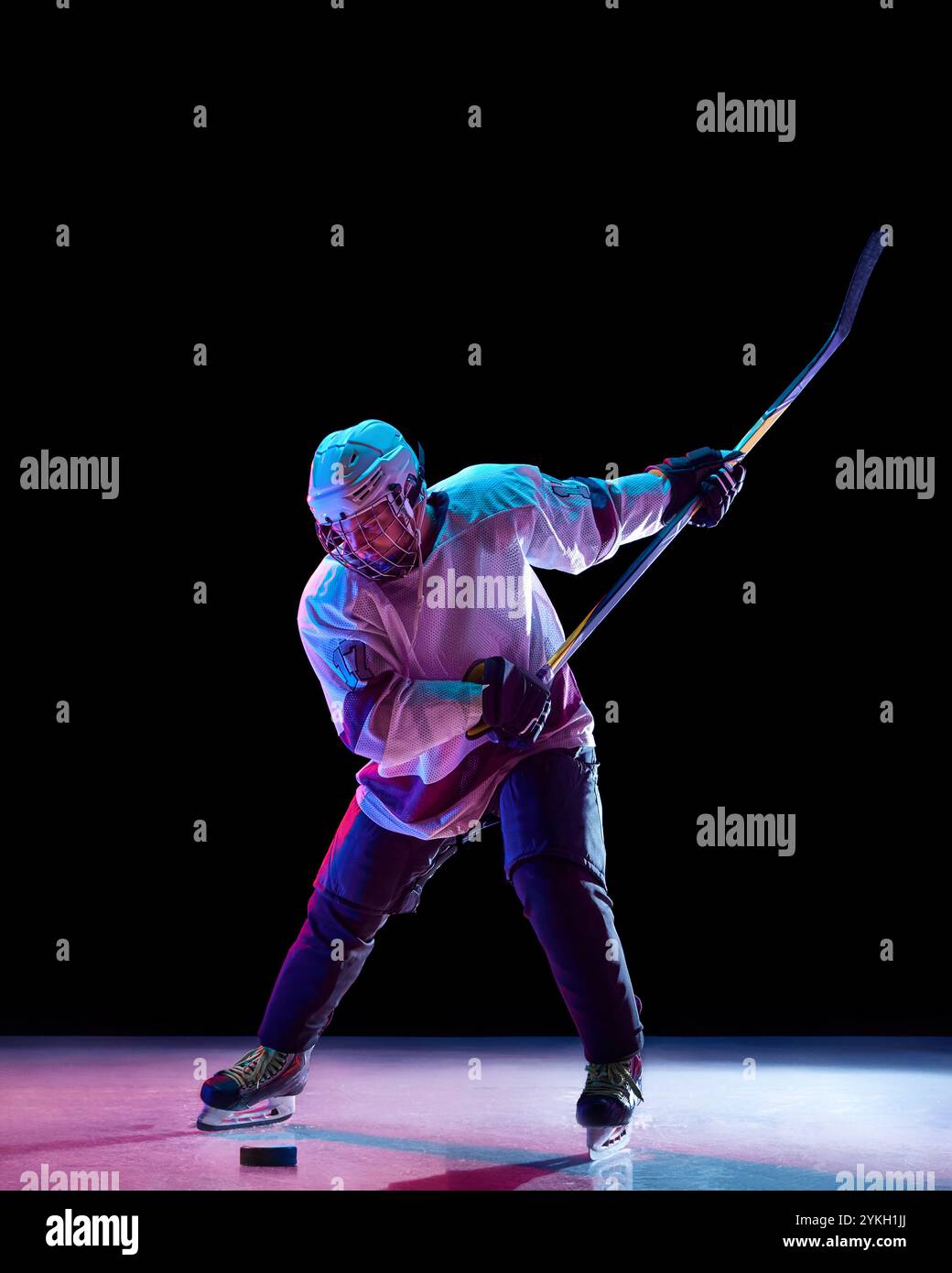 Competitive man, hockey player wearing full game gear, in motion with ...