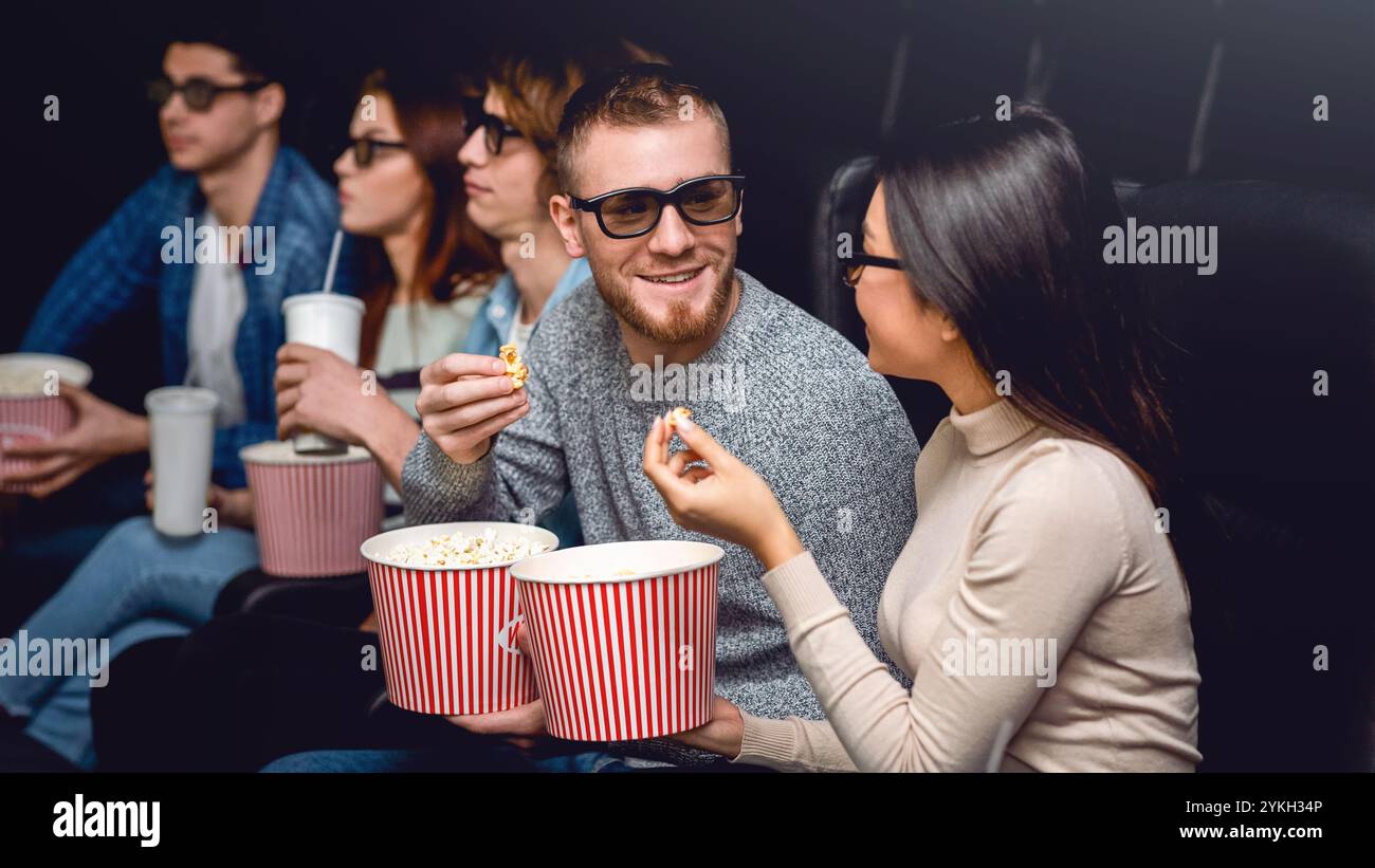 Friends in 3D glasses talking while waiting for movie premiere in ...
