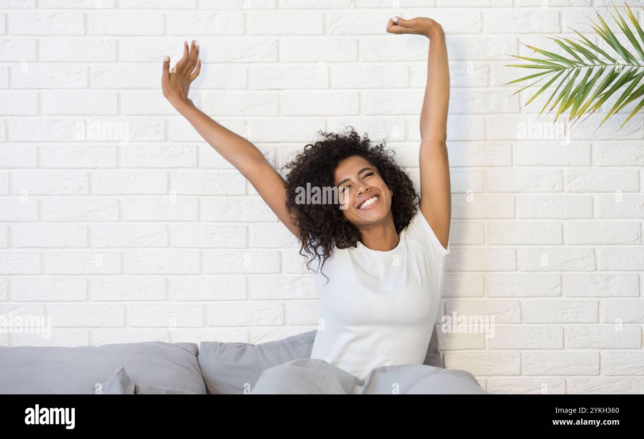 Beautiful black woman waking up in her bed Stock Photo - Alamy