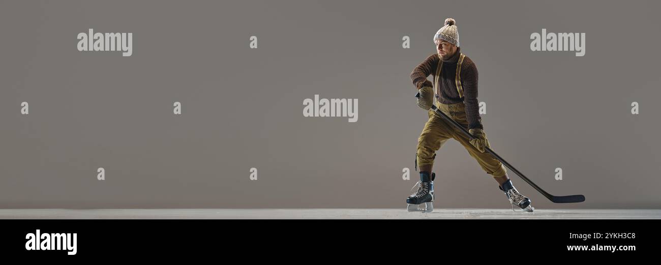 Barded man, hockey player wearing sweater, hat, pants with suspenders ...