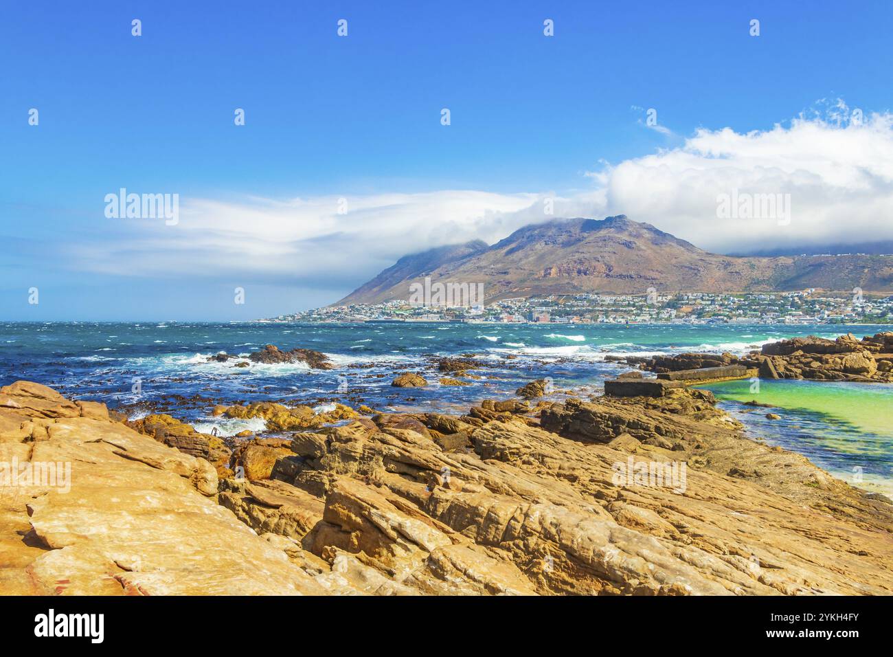 False Bay rough coast landscape with boulders waves and mountains with ...