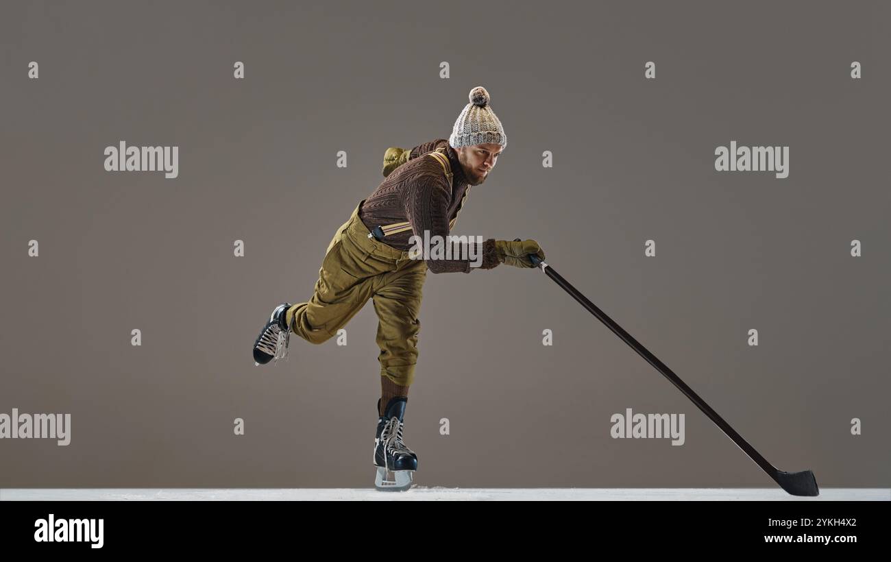Winter sports. Man wearing knitted sweater, hat and pants with ...
