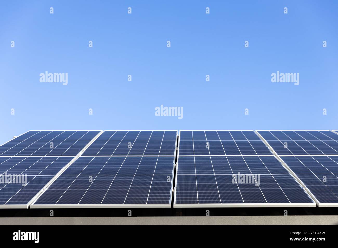 Aerial view of solar panel cells on clear blue sky background. Clean ...