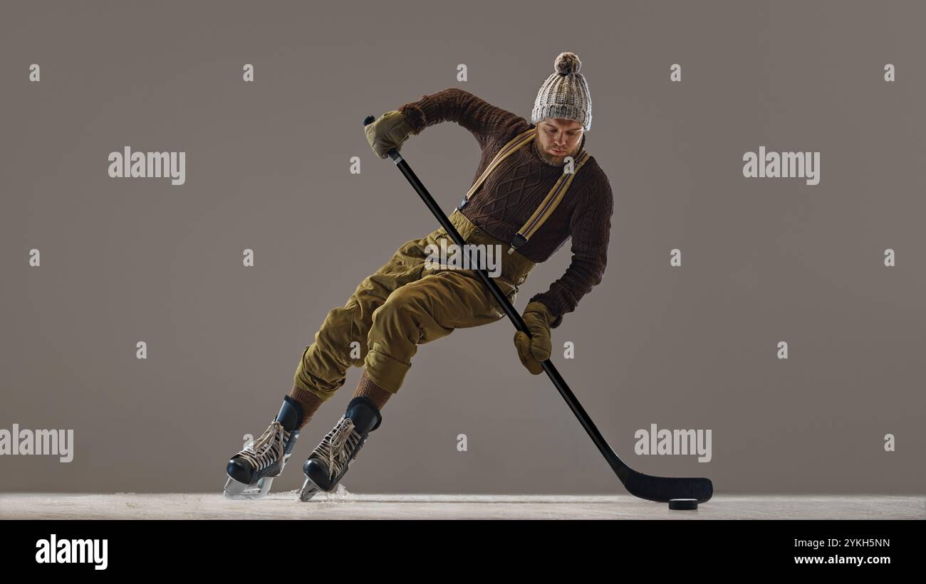 Winter sports. Man wearing knitted sweater, hat and pants with ...
