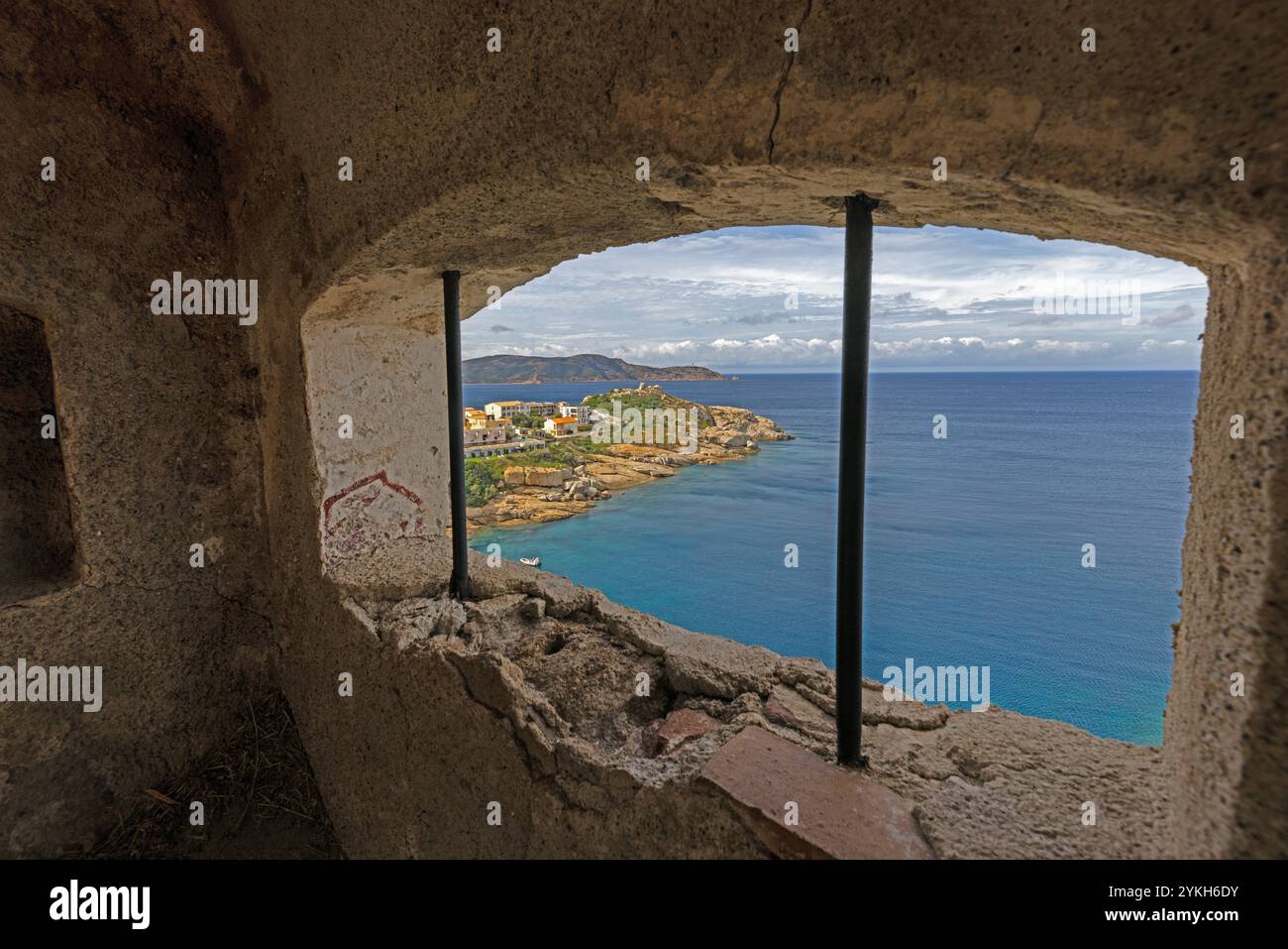 View through a fortress window overlooking a scenic bay and coastal ...