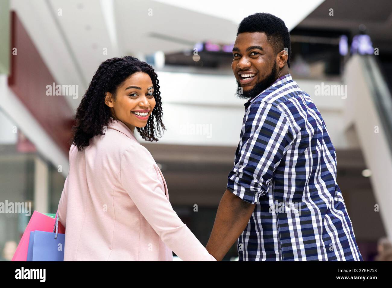 Couple's Leisure. Black Man And Woman Walking In Shopping Mall, Holding ...