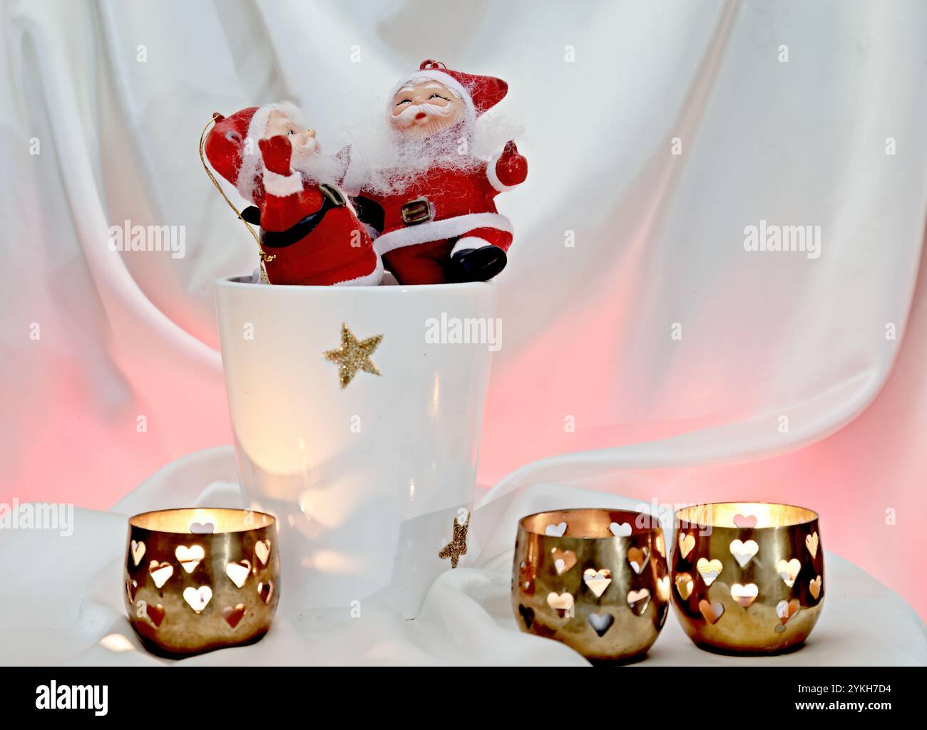 Two joyful santa figures standing in a ceramic pot Stock Photo - Alamy