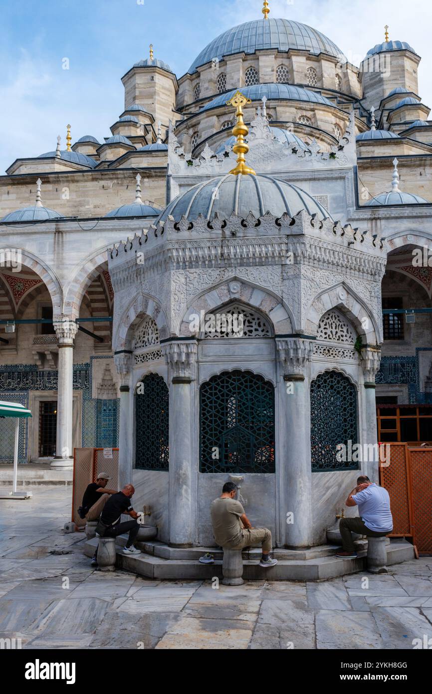 Men carrying out Wudu, the purification ritual before prayer at the ...