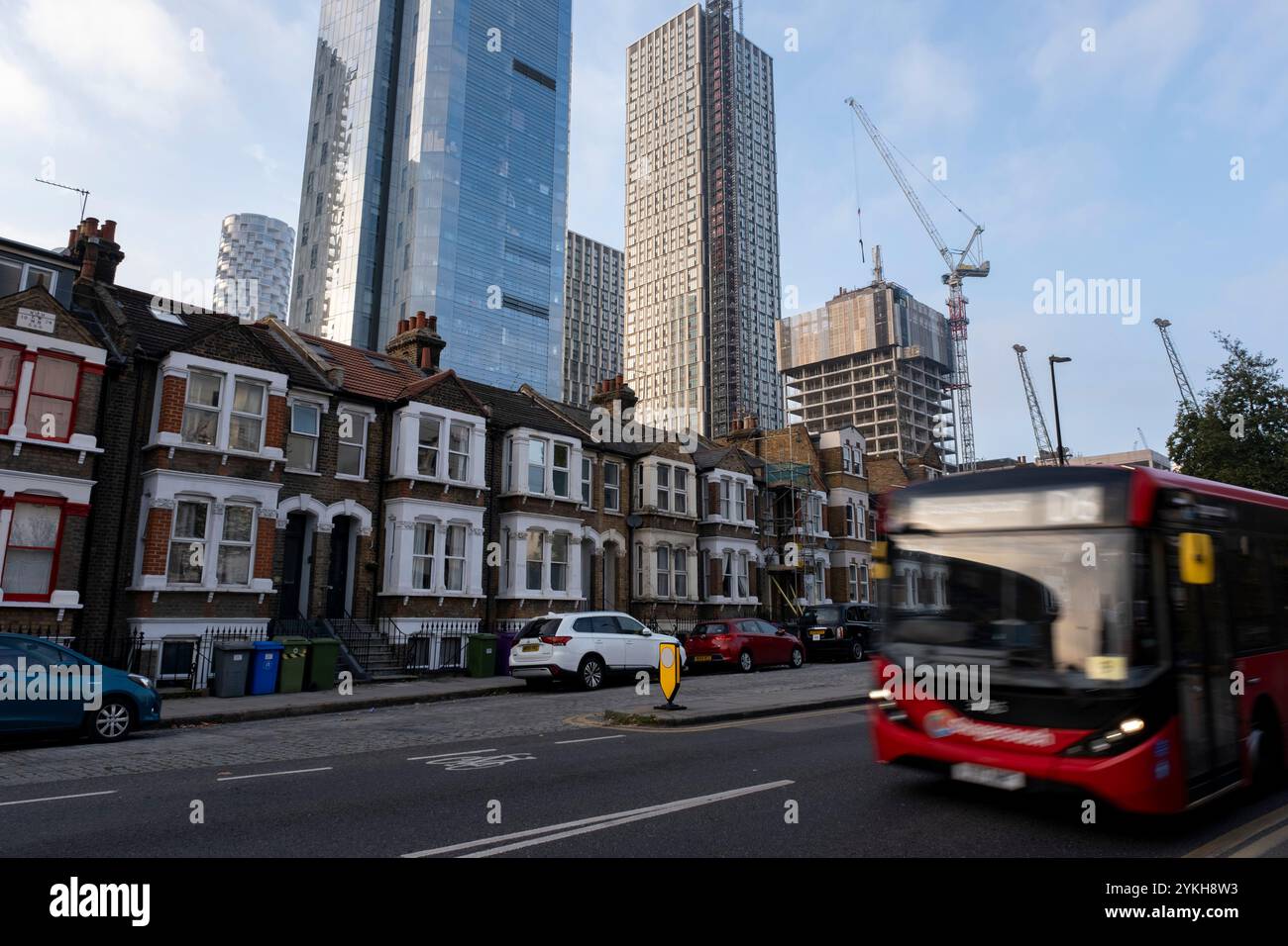 New high rise apartment block towers over an old terrace of low rise ...