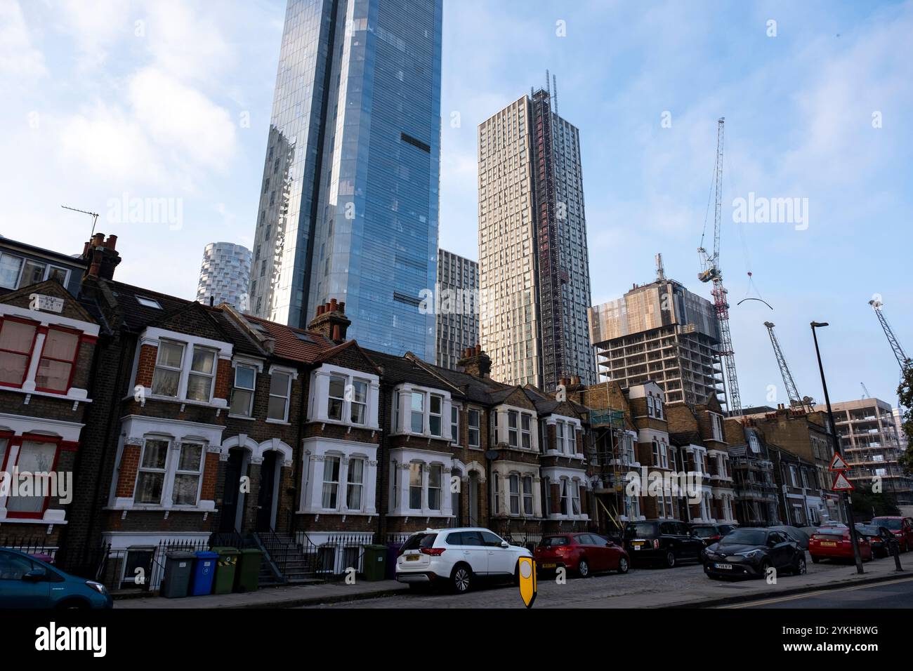 New high rise apartment block towers over an old terrace of low rise ...