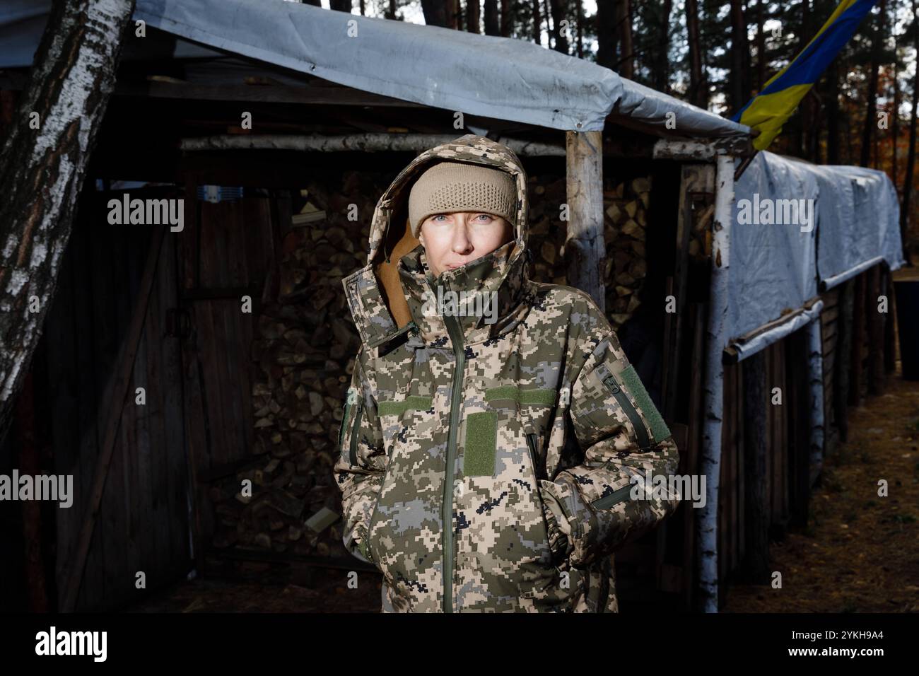 A young woman in camouflage during a military training of the female ...