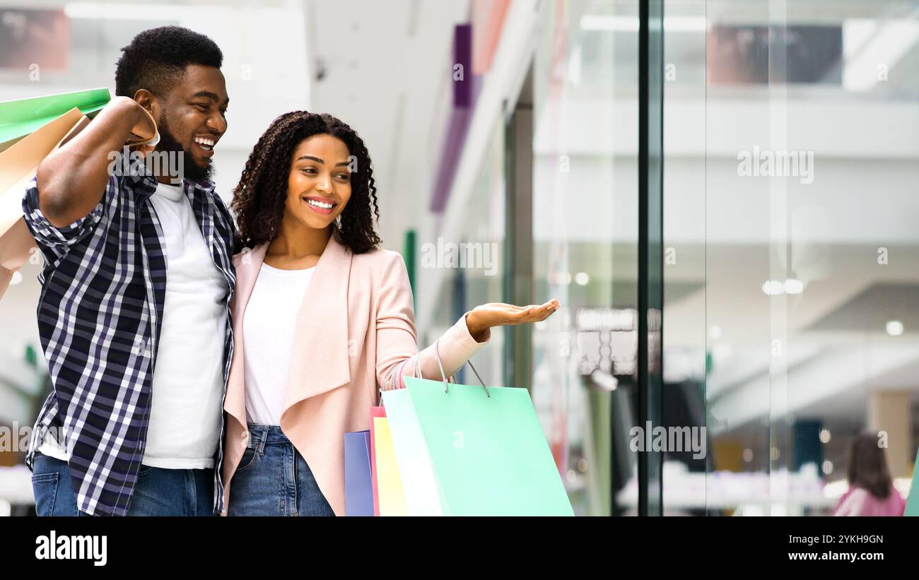 Discount Prices. Smiling Black Couple Shopping In Mall Together ...