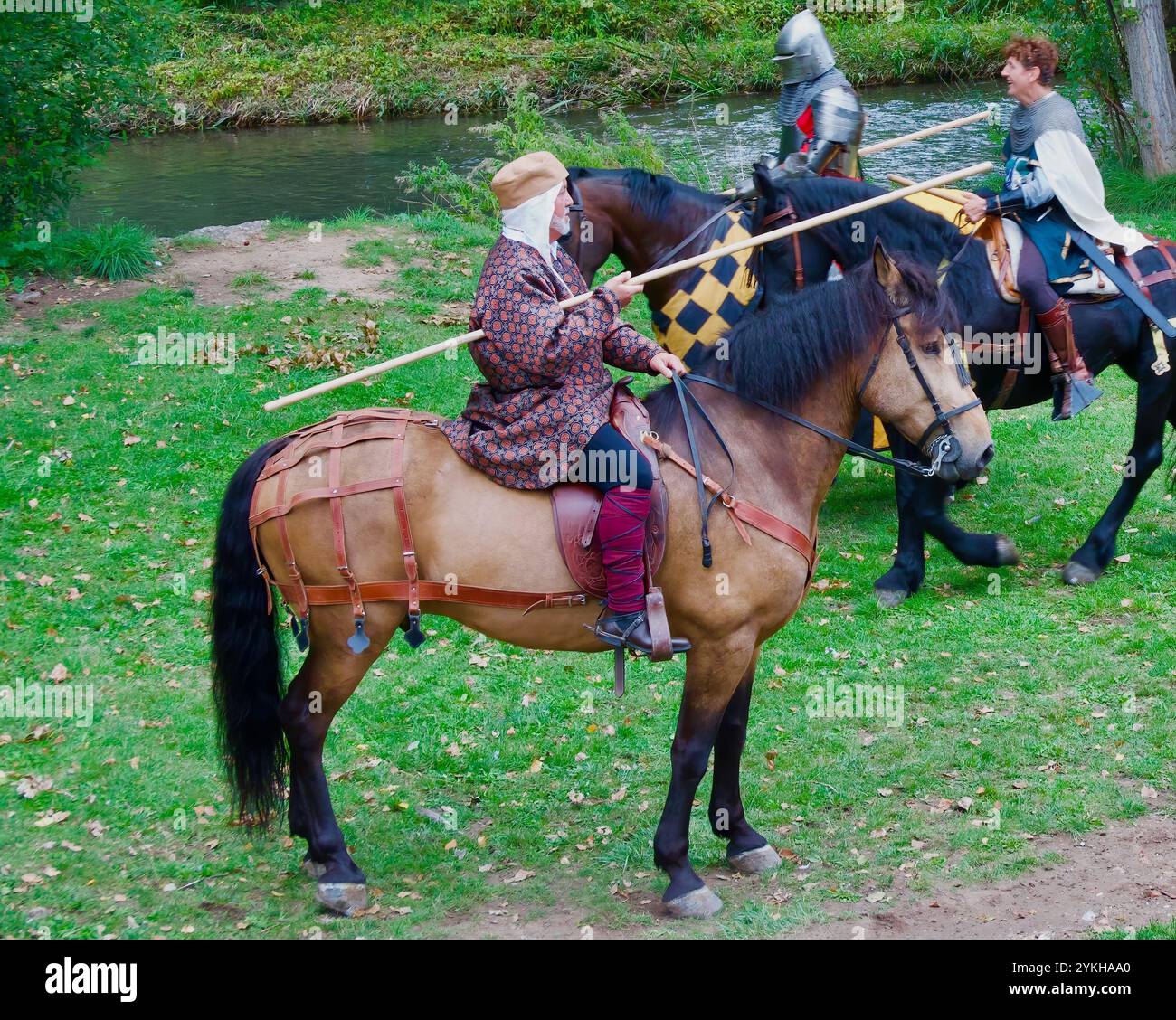 Participants in medieval costumes riding caparisoned horses during a ...