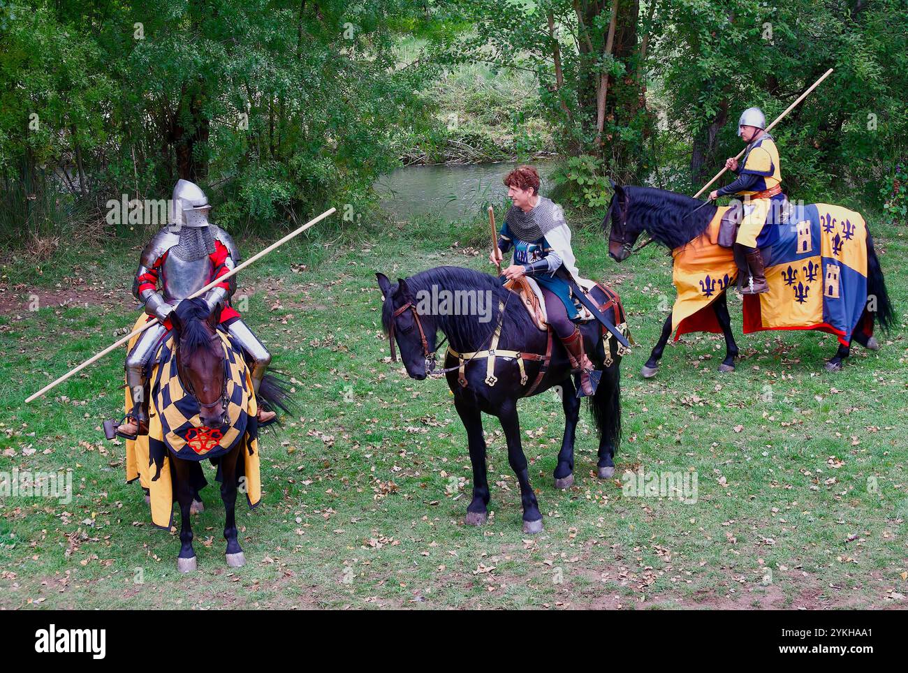Participants in medieval costumes riding caparisoned horses during a ...