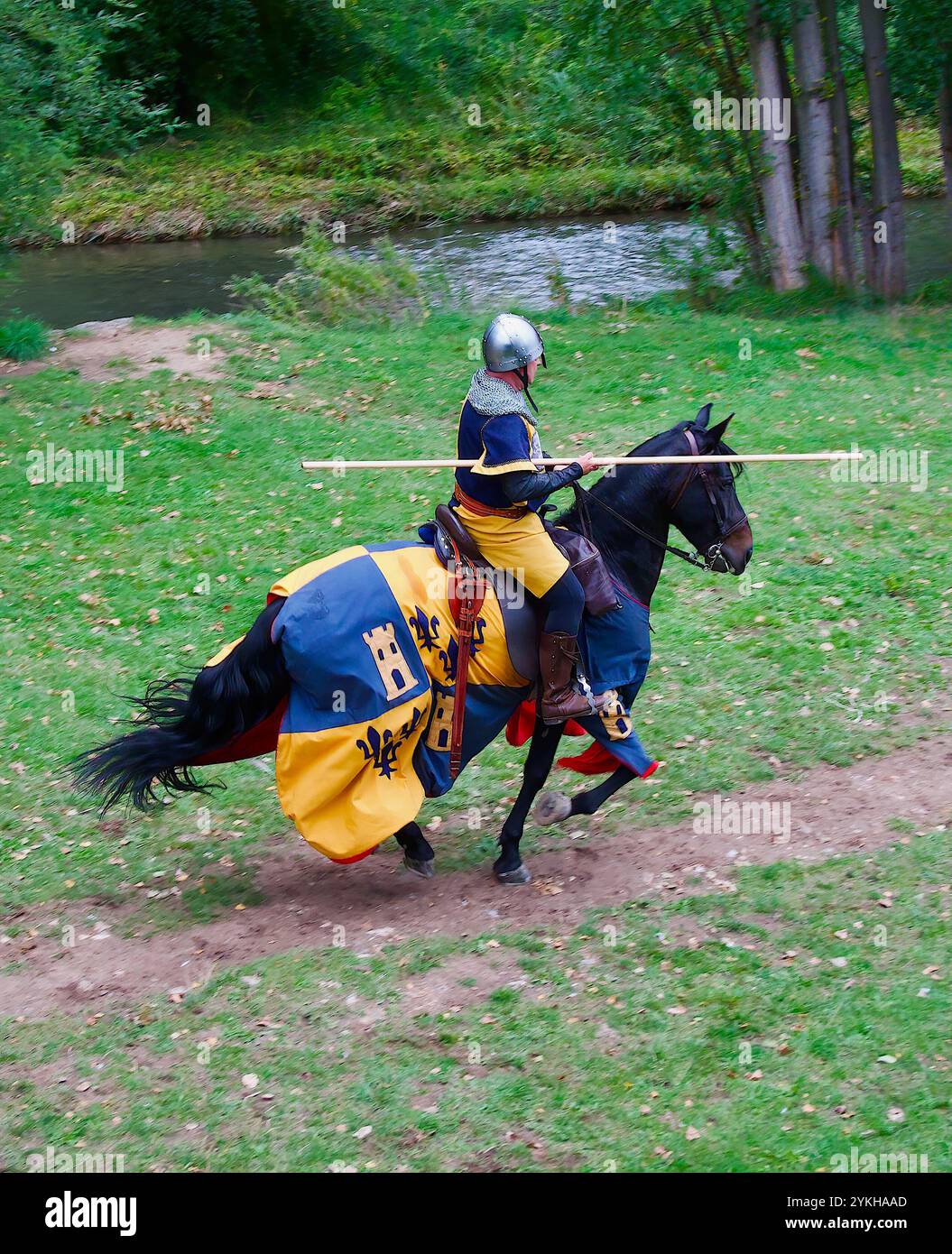 Man in medieval costume rides a caparisoned horse during a historical ...