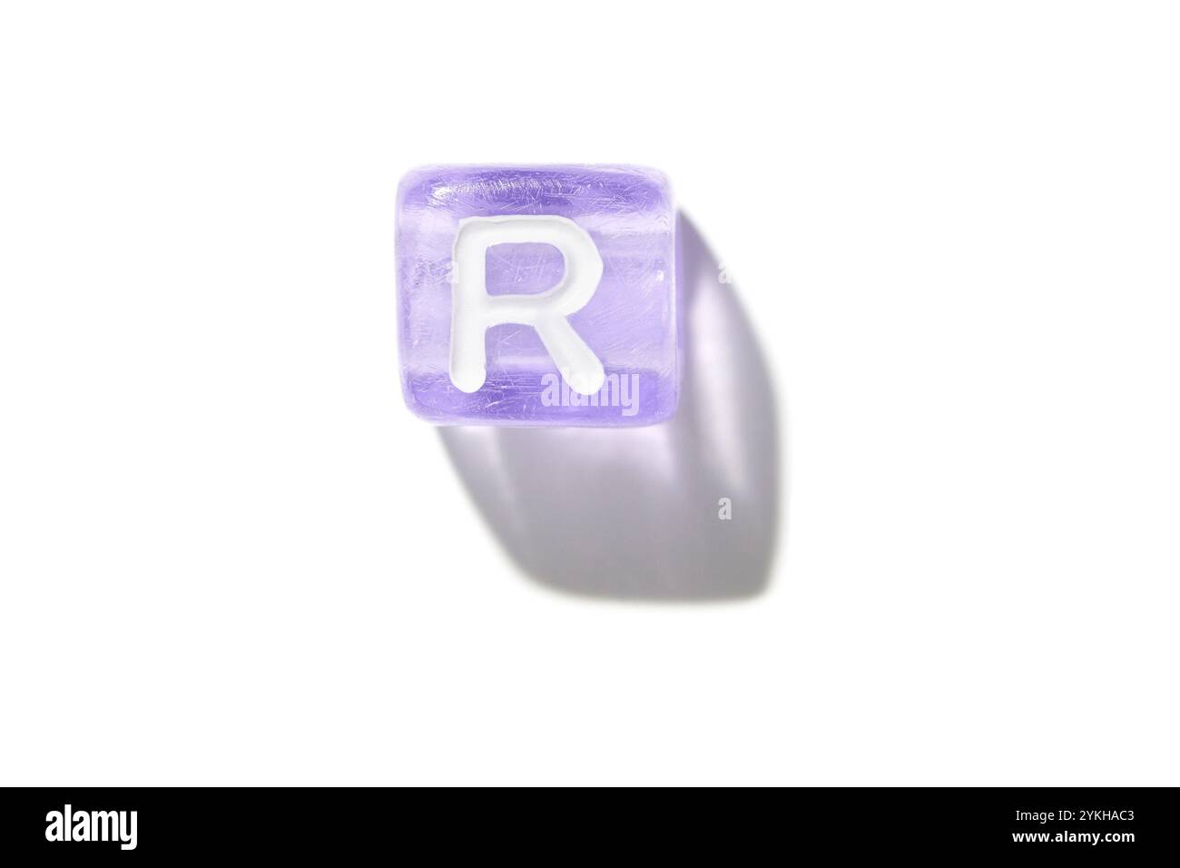 Purple translucent ice cube with letter r on white background Stock Photo - Alamy