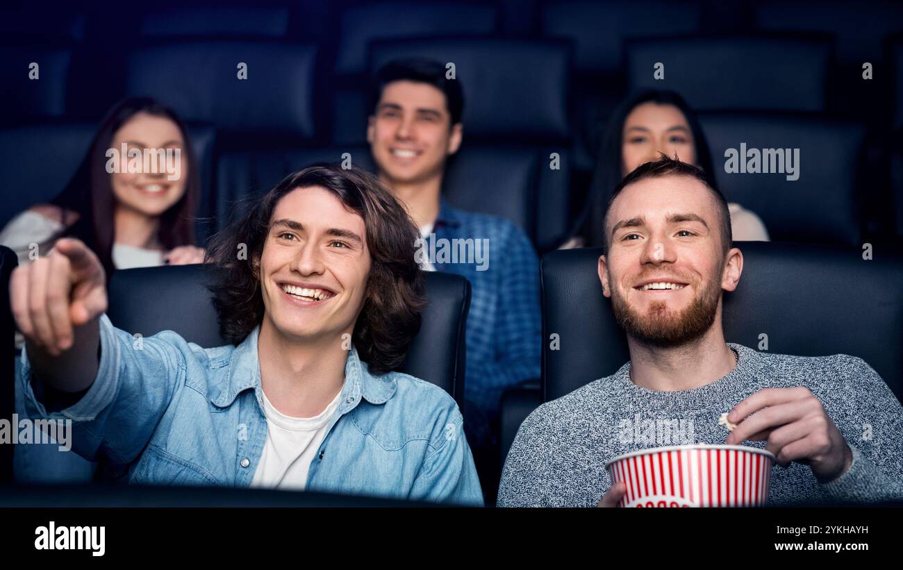 Weekend activity. Young friends on movie night in cinema Stock Photo ...