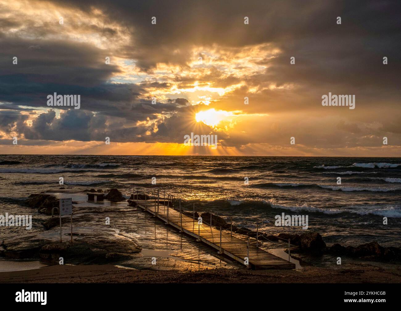 Setting sun through rain clouds, November, Paphos coastal path, Cyprus ...