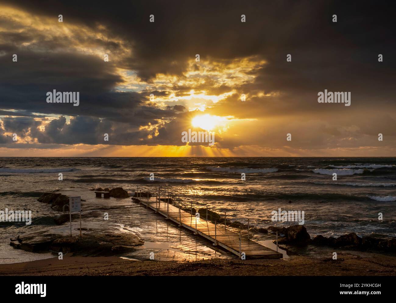 Setting sun through rain clouds, November, Paphos coastal path, Cyprus ...
