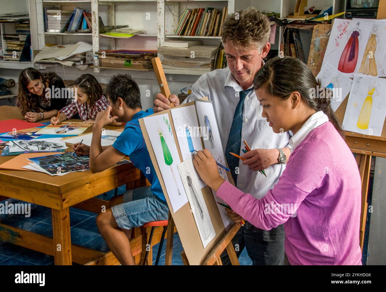 School Art Class fashion design with teacher and teenage girl pupil ...