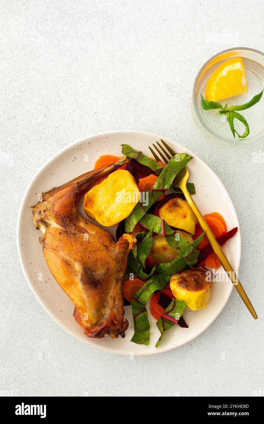 Enjoy a delicious, hearty meal with baked rabbit, roasted potatoes, and ...