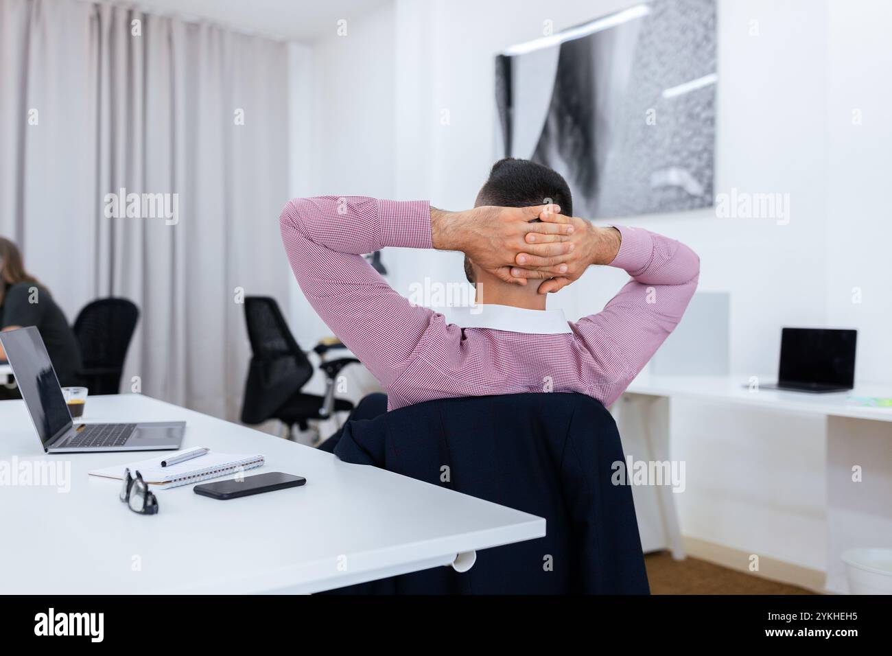 Relaxed office worker taking a break in a modern workspace environment ...