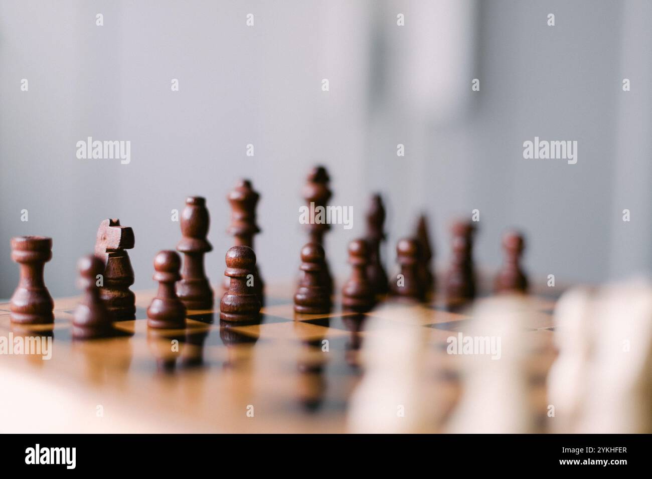 A chess board with pieces on it. The board is black and white. The ...