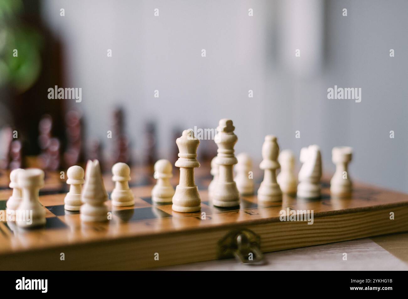A chess board with pieces on it. The board is black and white. The ...
