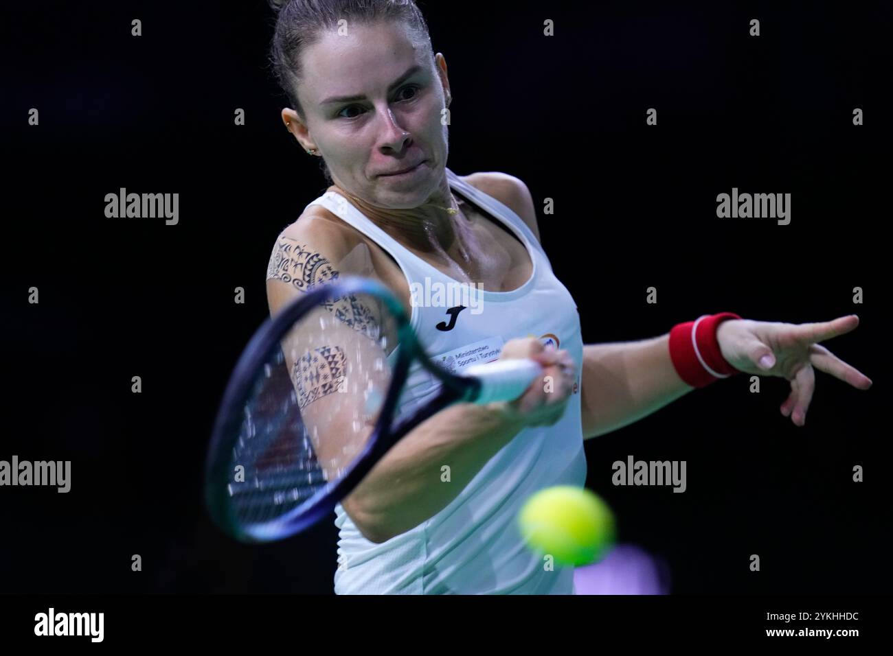 Poland's Magda Linette returns the ball to Italy's Lucia Bronzetti ...