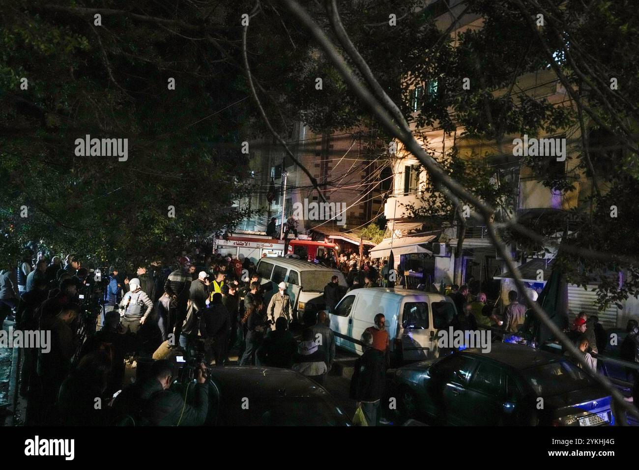 Residents and rescuers gather at the site of an Israeli airstrike in ... Residents and rescuers gather at the site of an Israeli airstrike in ...