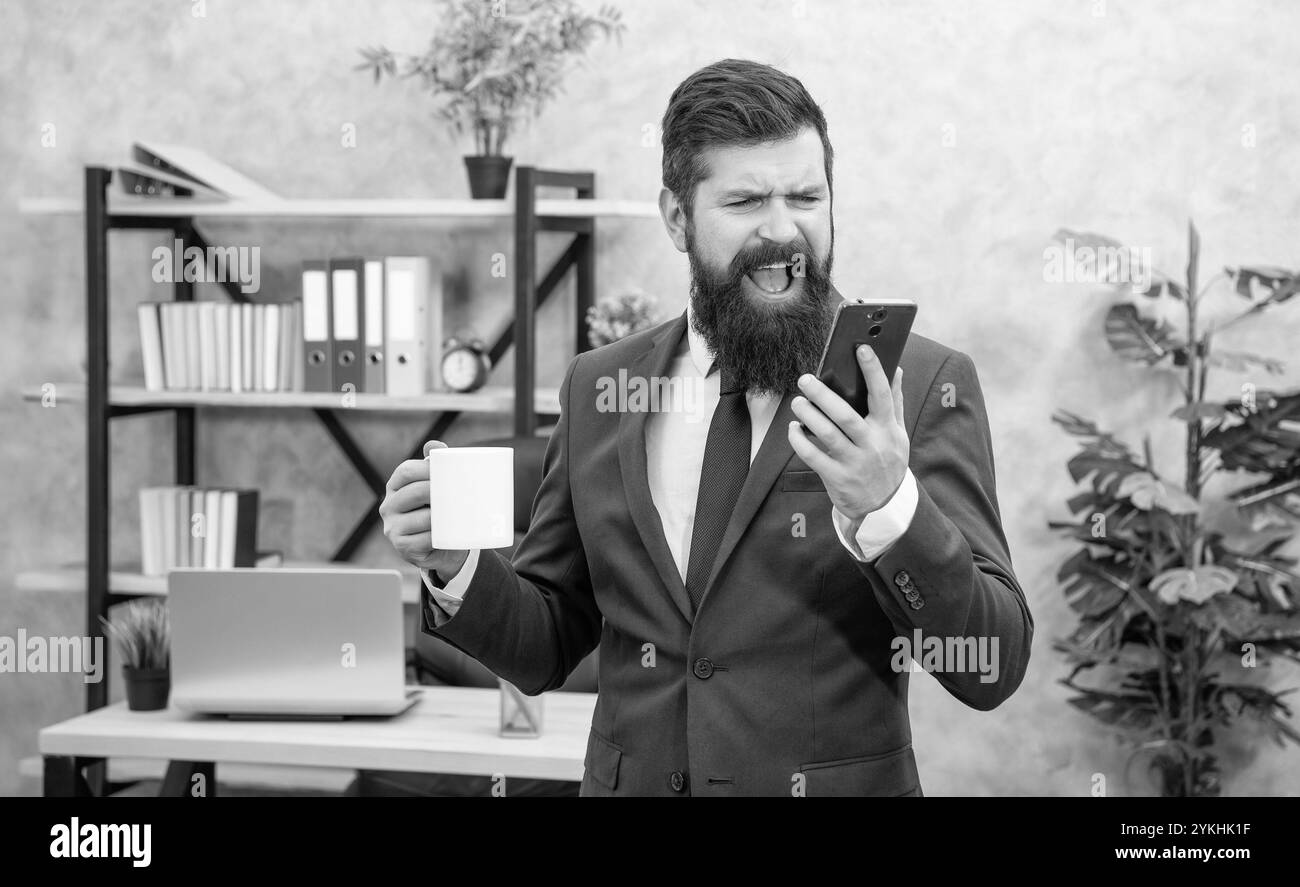 Stressed manager yelling in anger while talking on mobile phone in ...