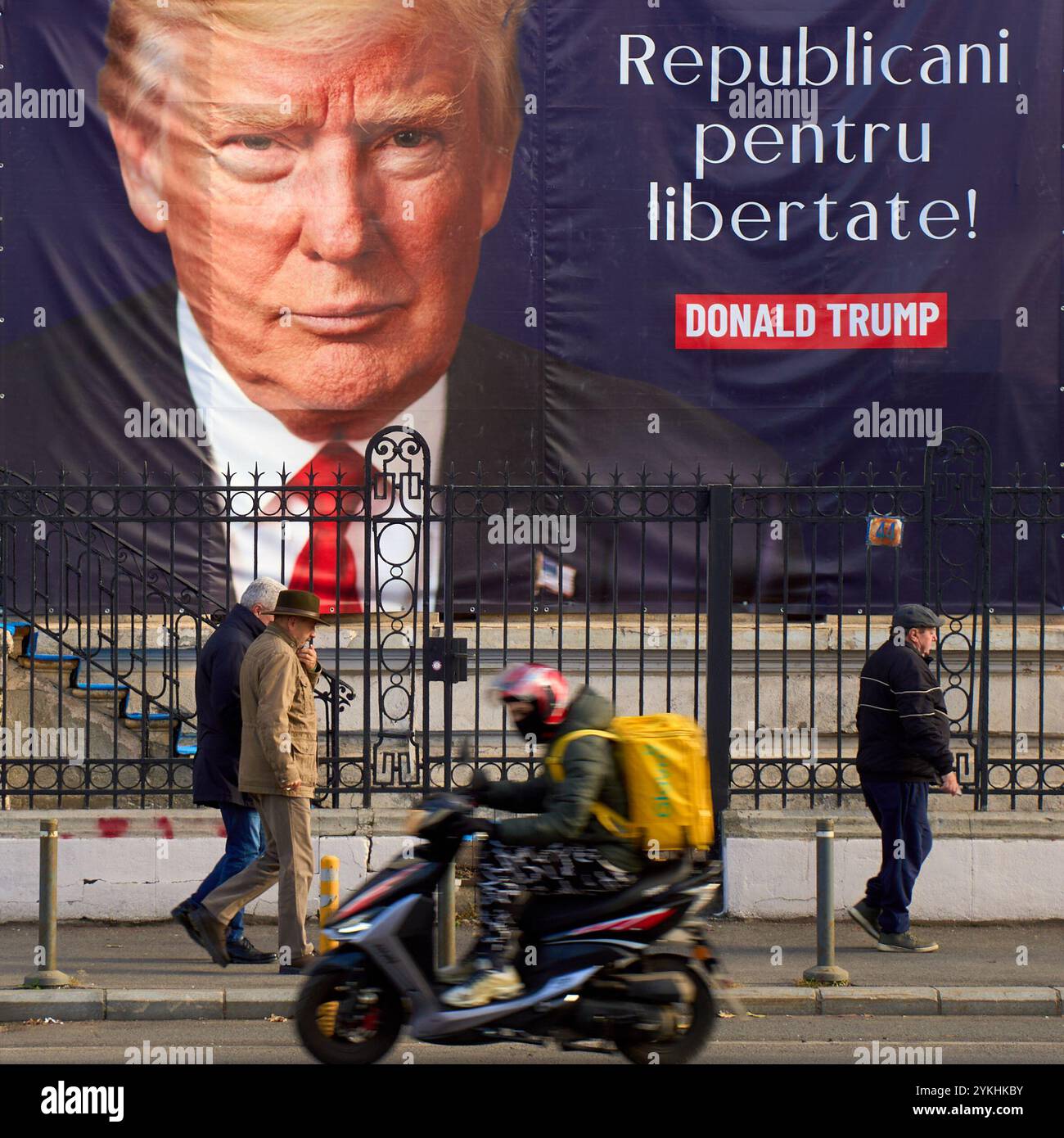 Bucharest, Romania. 18th Nov, 2024: People walk past a banner showing ...