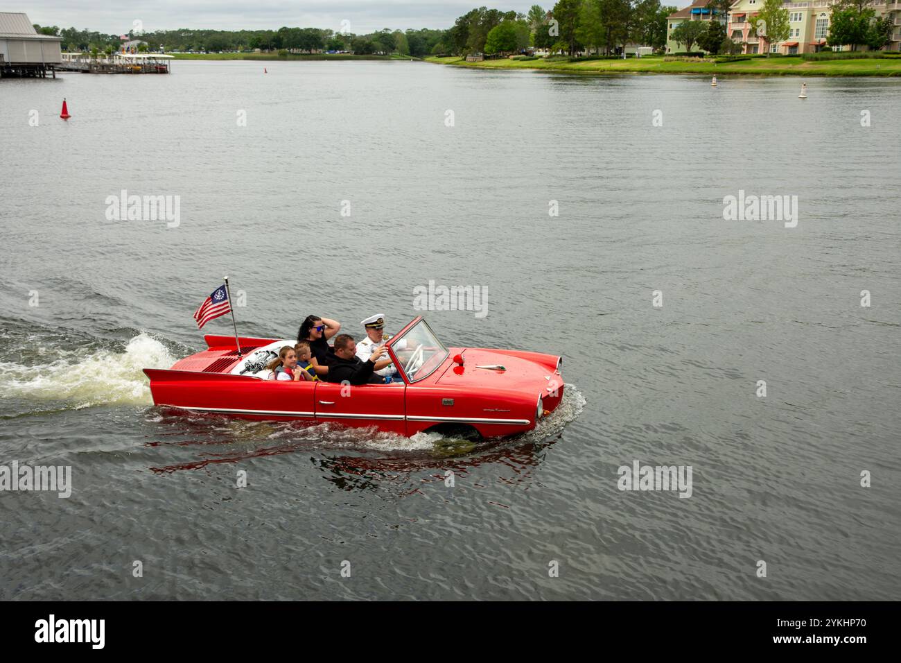 Amphibious vehicle transitioning from land to water, with passengers on ... Amphibious vehicle transitioning from land to water, with passengers on ...