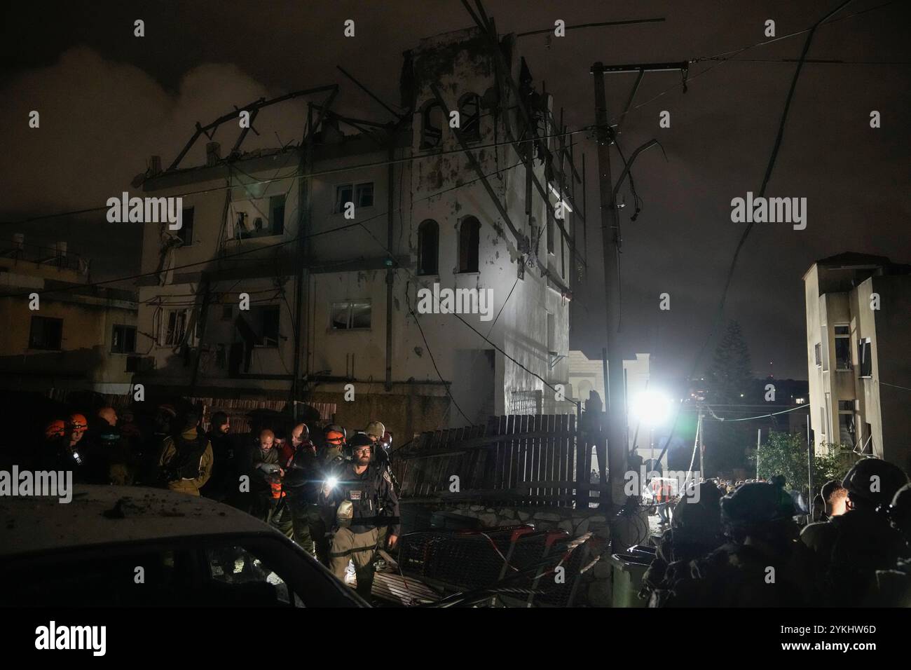 CORRECTS TOWN NAME: Police and rescue workers stand next to a building ...