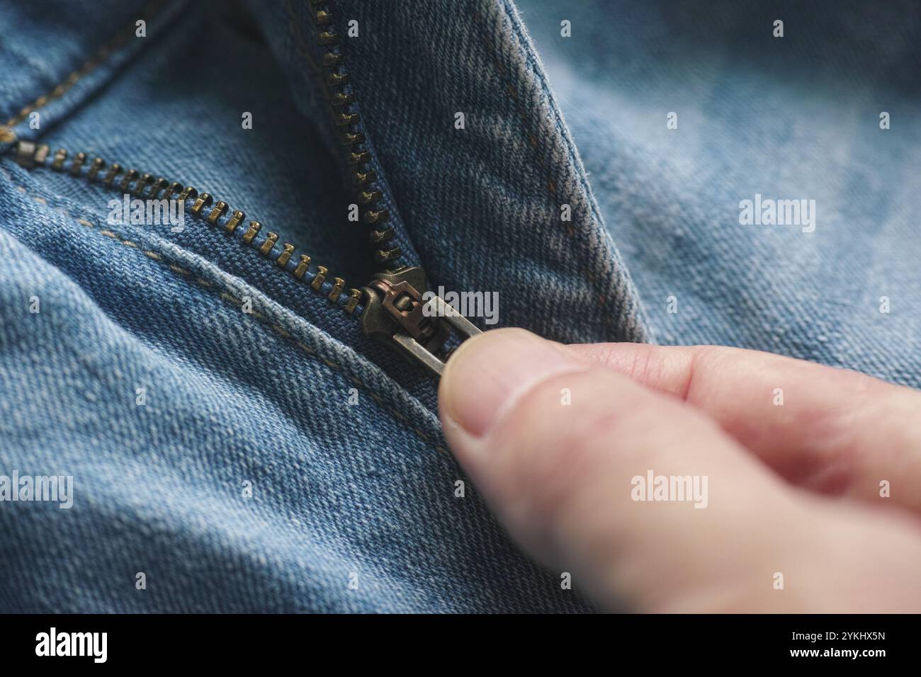 A man unzipping jeans. Close up Stock Photo - Alamy