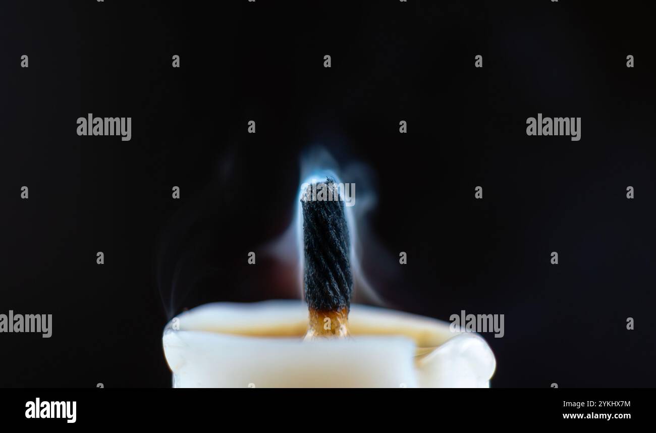 Candle wick smoking after being extinguished in darkness Stock Photo ...