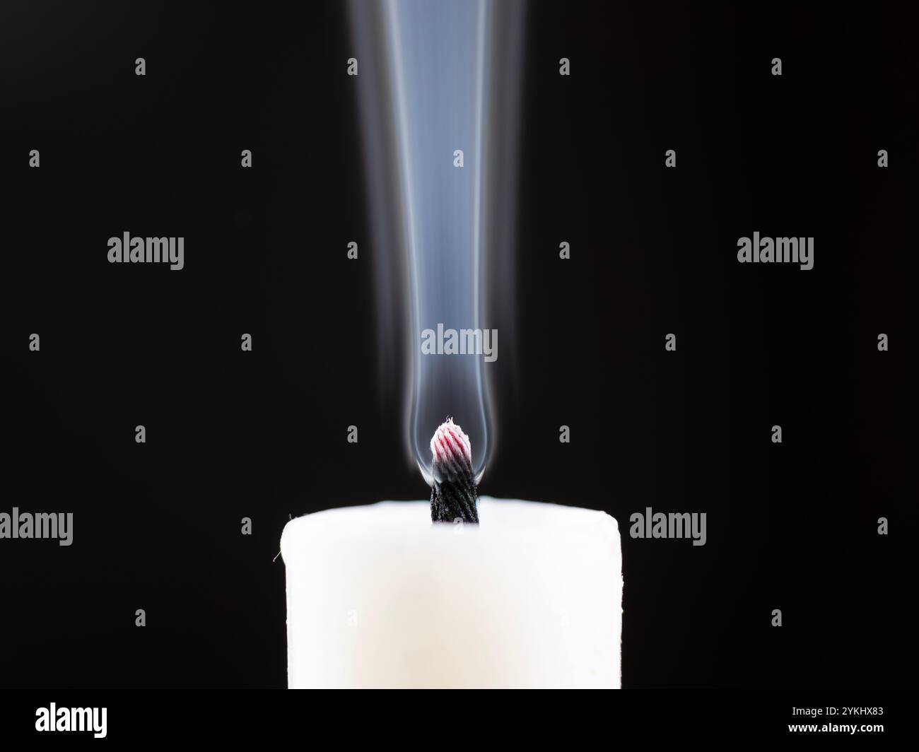 Candle wick smoking after being extinguished in darkness Stock Photo ...