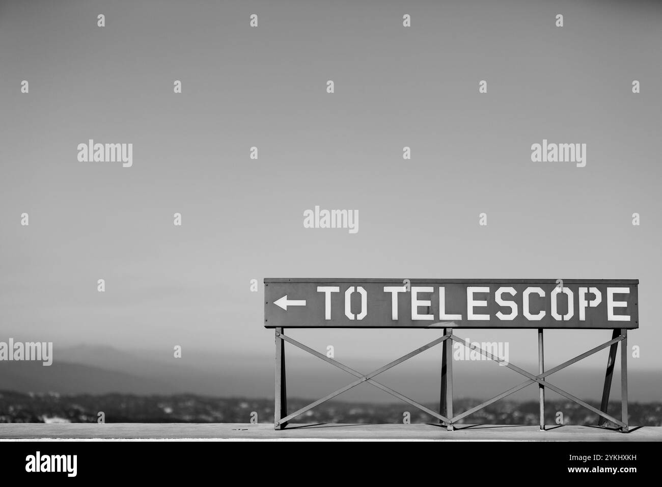Minimalistic sign pointing to telescope in black and white Stock Photo ...