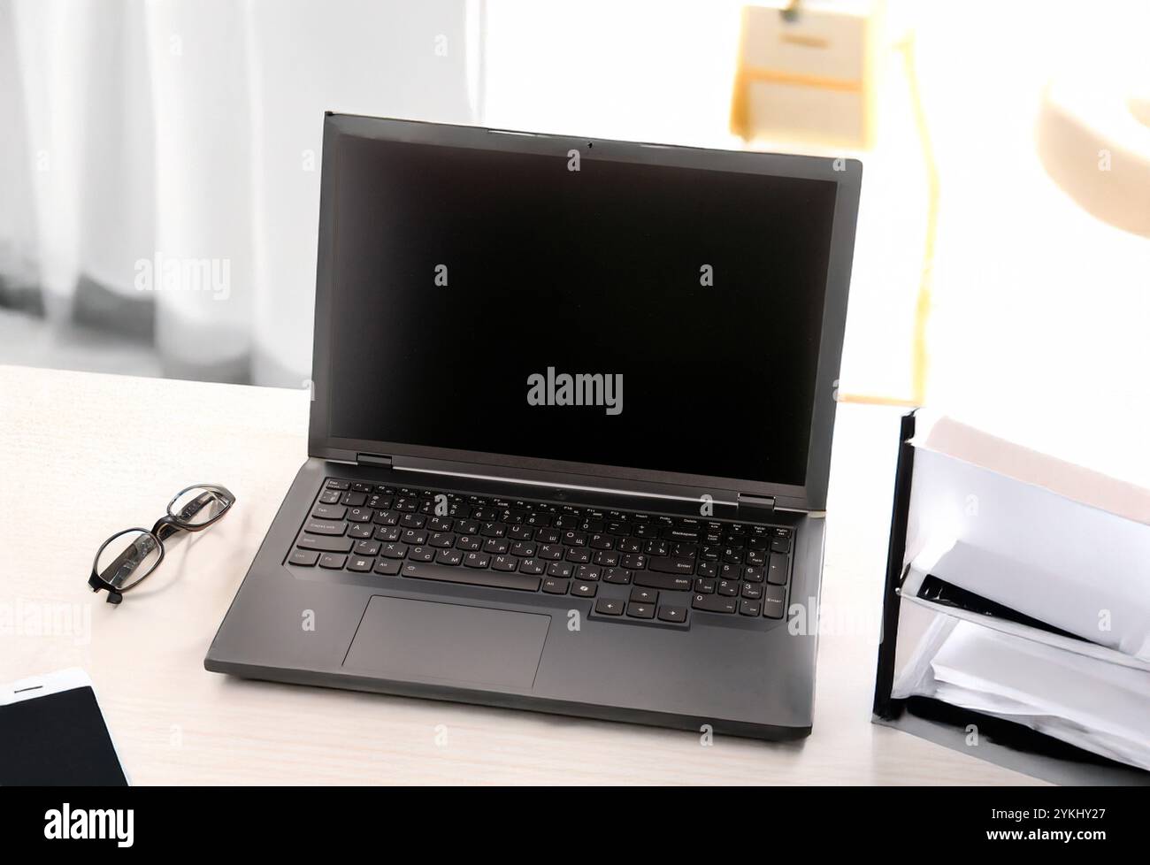 One, gray, laptop, close-up, on an office desk Stock Photo - Alamy