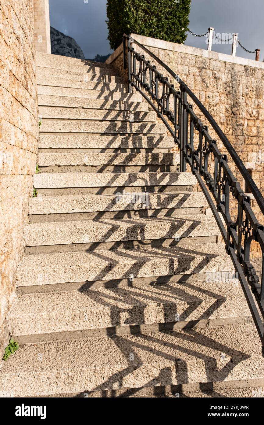 Wrought iron railing with concrete stairs. Iron banister. Elements ...